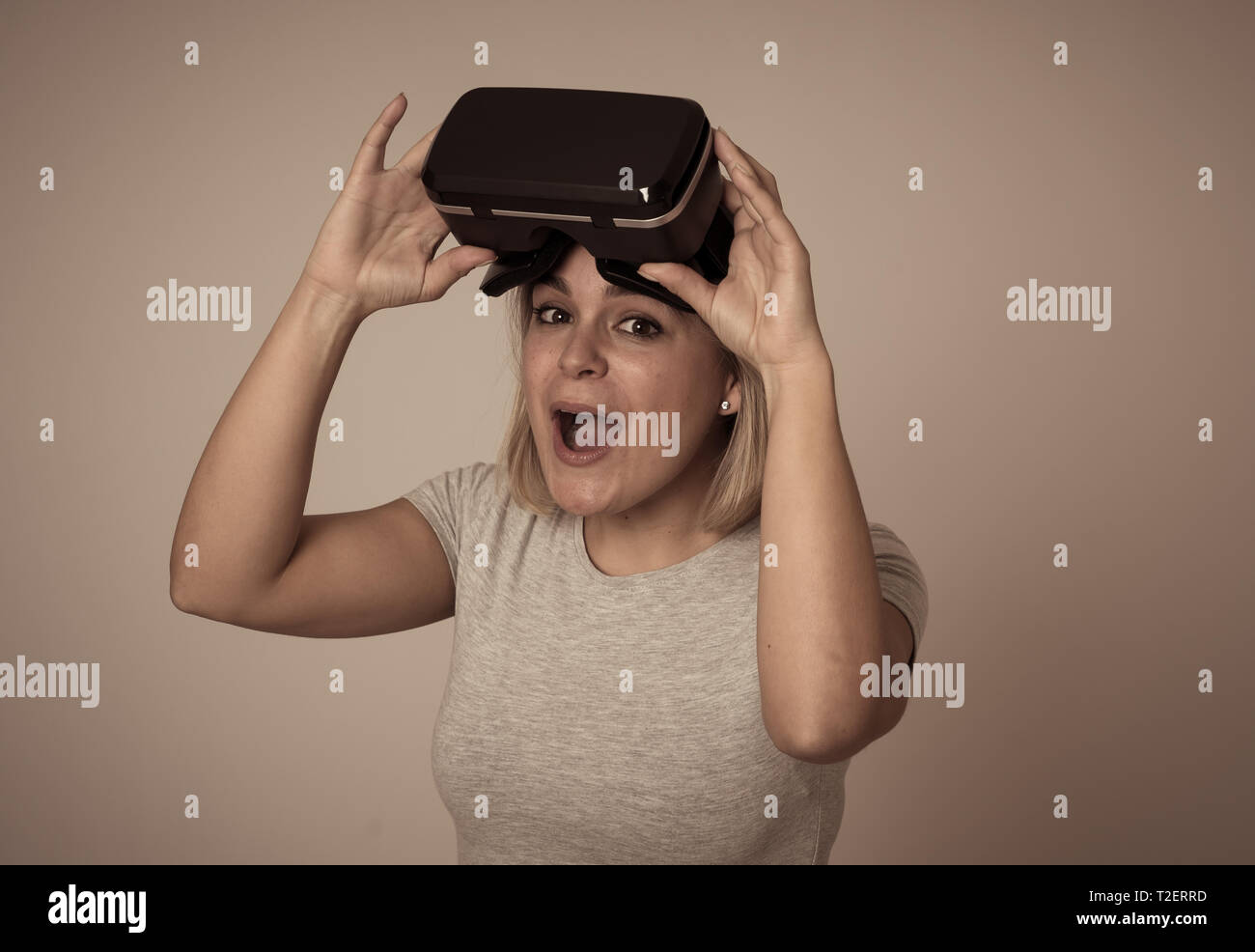 Curious woman happy and excited to use virtual reality goggles feeling ...