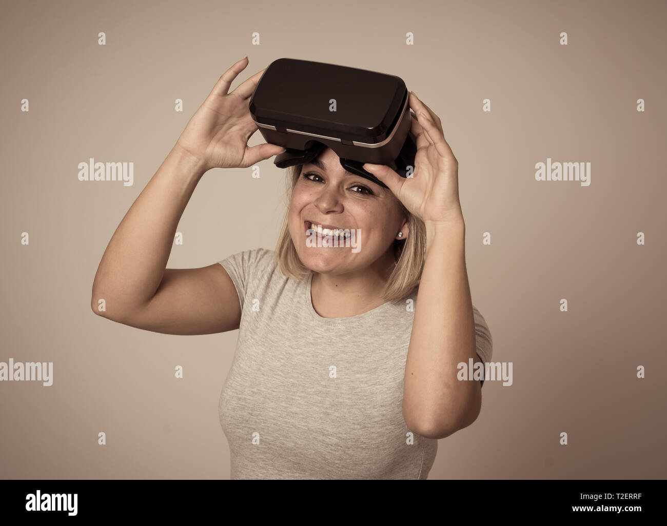 Curious woman happy and excited to use virtual reality goggles feeling ...