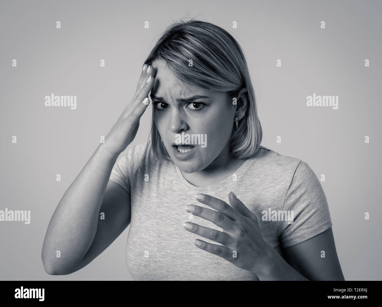 Black and white portrait of young woman feeling afraid and shocked ...