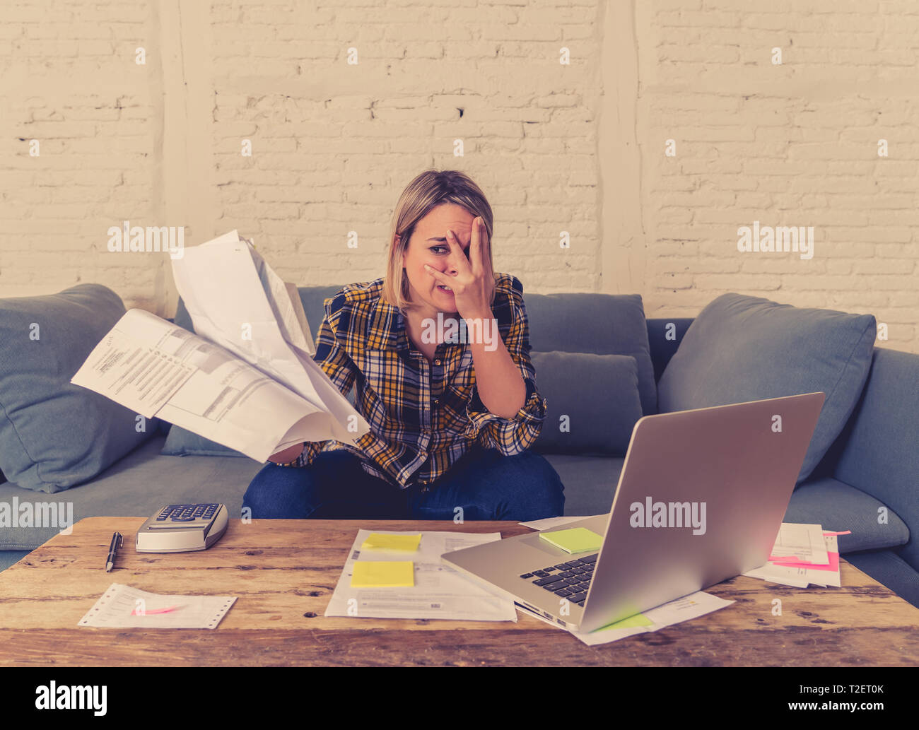 Portrait of desperate young woman feeling stressed checking online ...