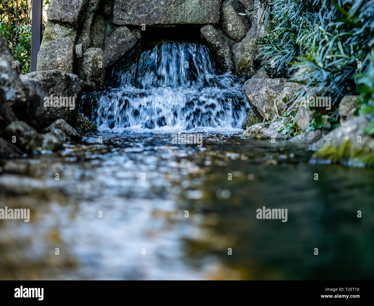 Water cascades from a water pumping station into a flowing water ...
