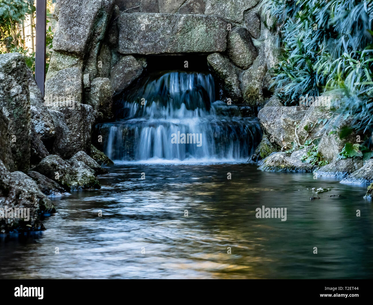Water cascades from a water pumping station into a flowing water ...