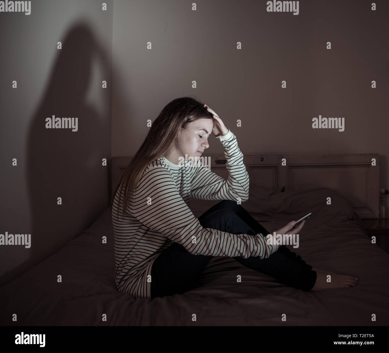 Young teenager girl suffering mobile cell phone addiction feeling ...