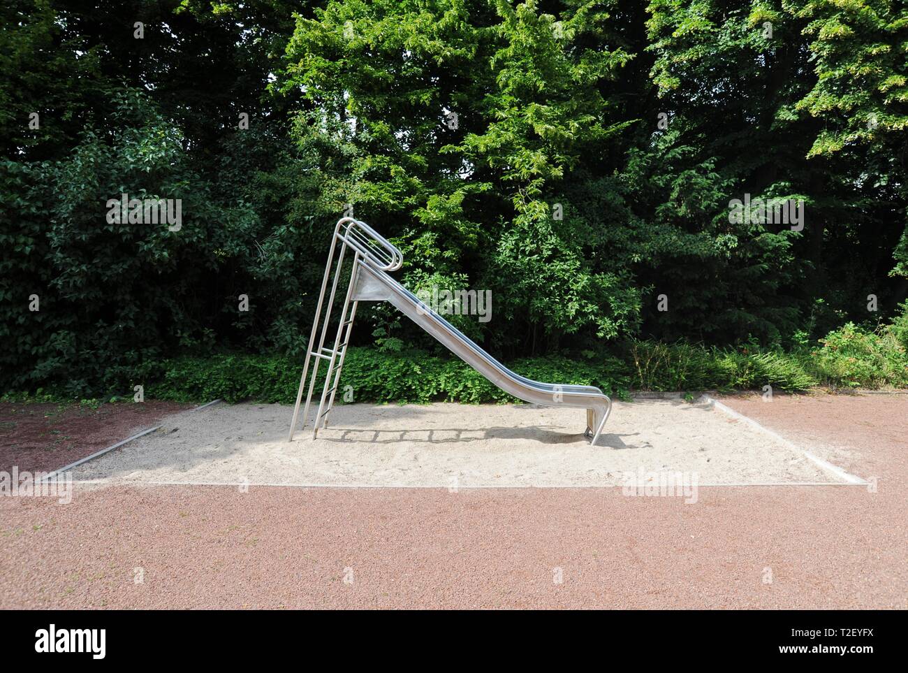 Lonely childrens playground with slide and sandpit without children hi ...