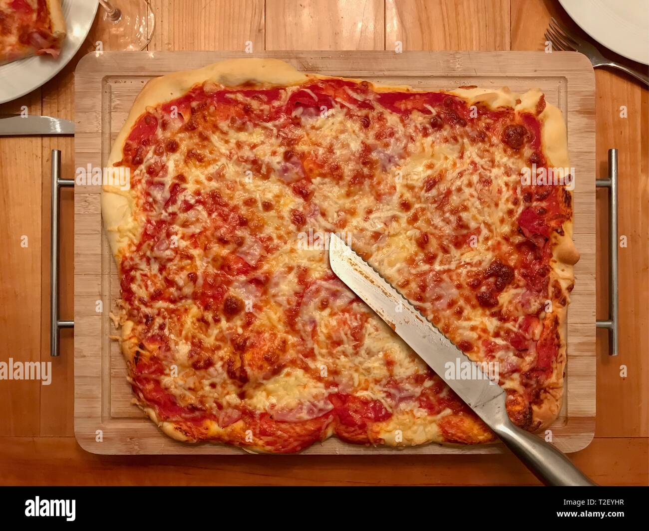 Homemade pizza with tomatoes and cheese on wooden board, Germany Stock ...