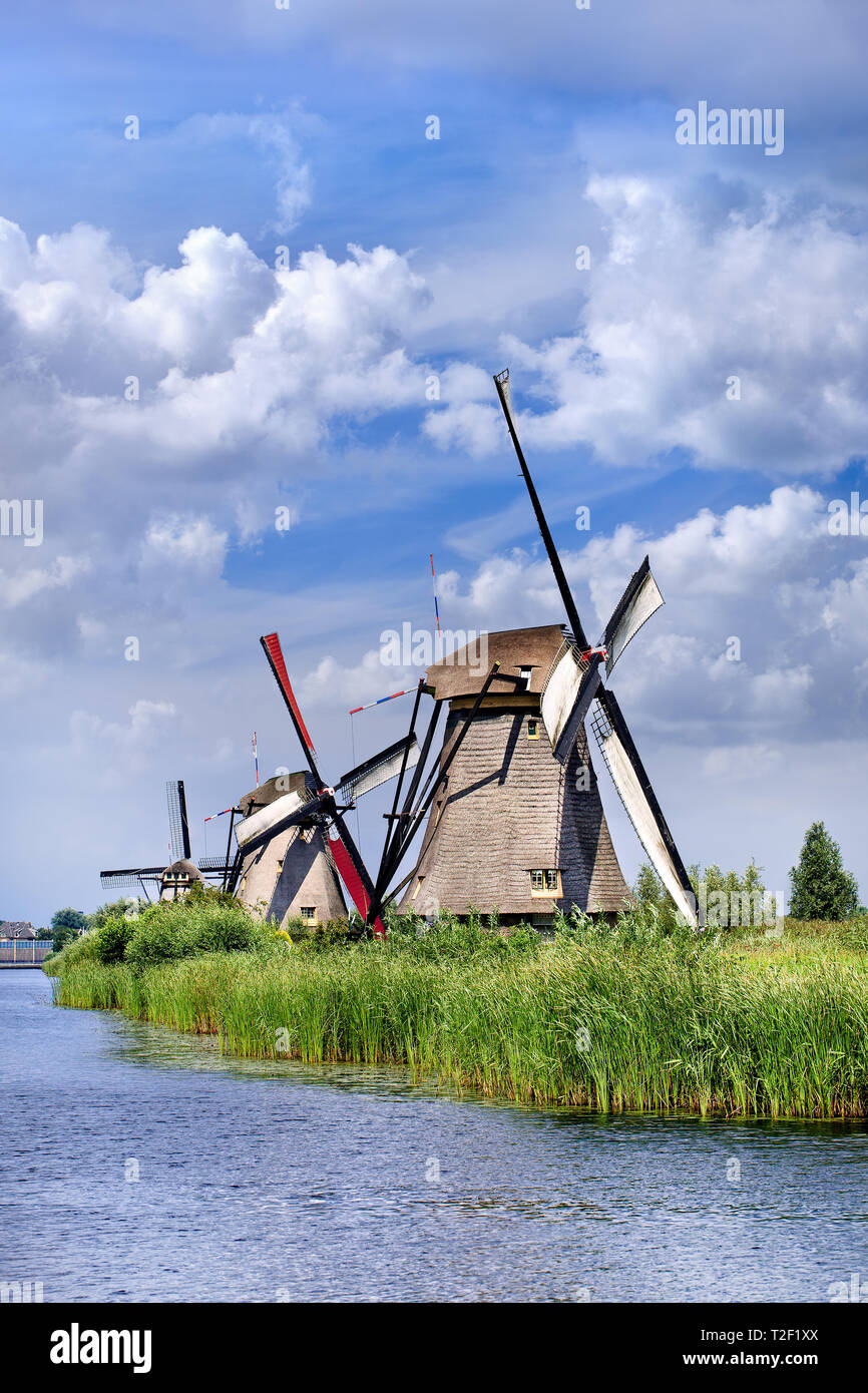 Ancient wind mills near a blue canal on a summer day at the famous ...