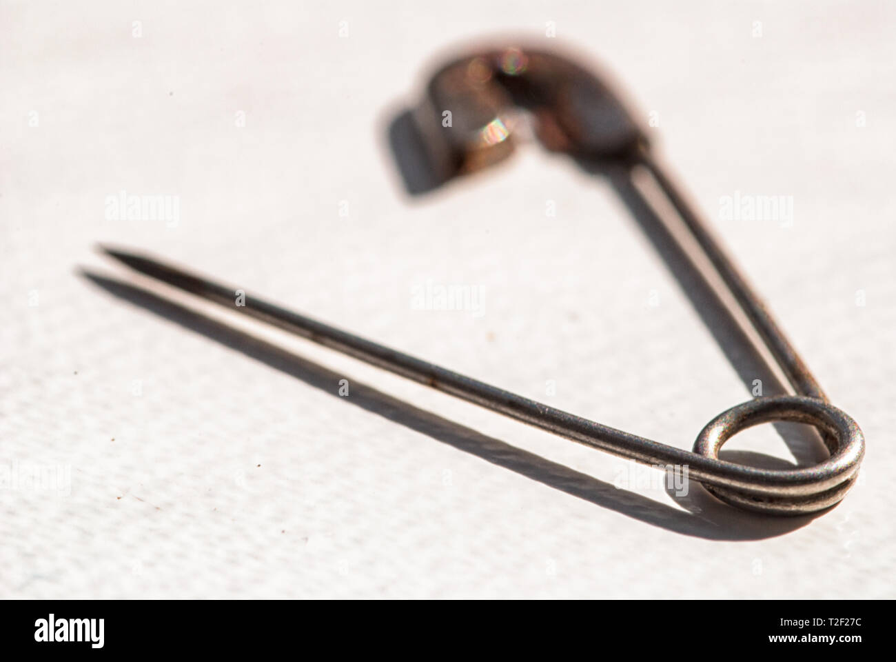 metal pin on white background macro concept of dressmaking Stock Photo ...