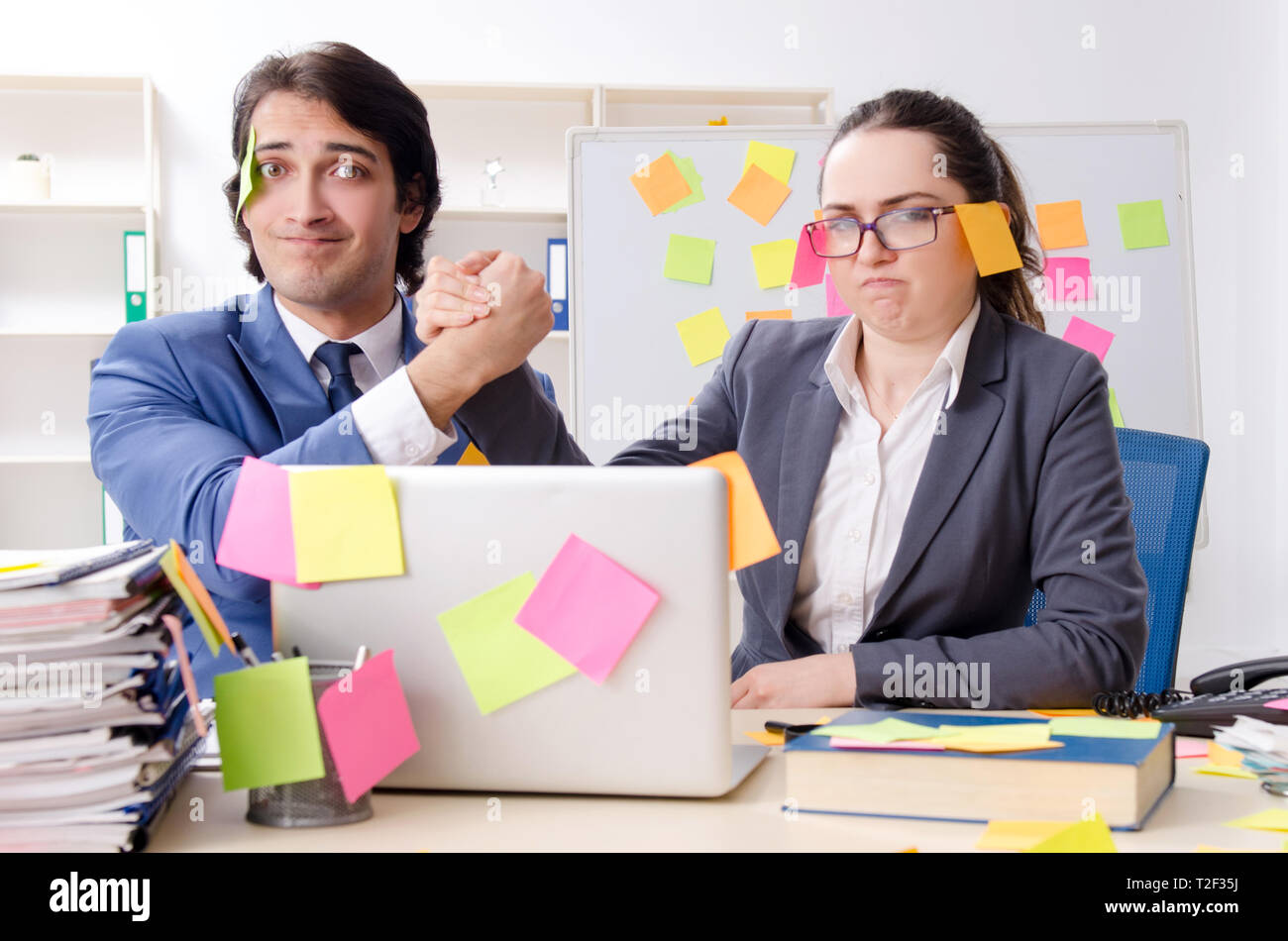Two colleagues employees working in the office Stock Photo - Alamy