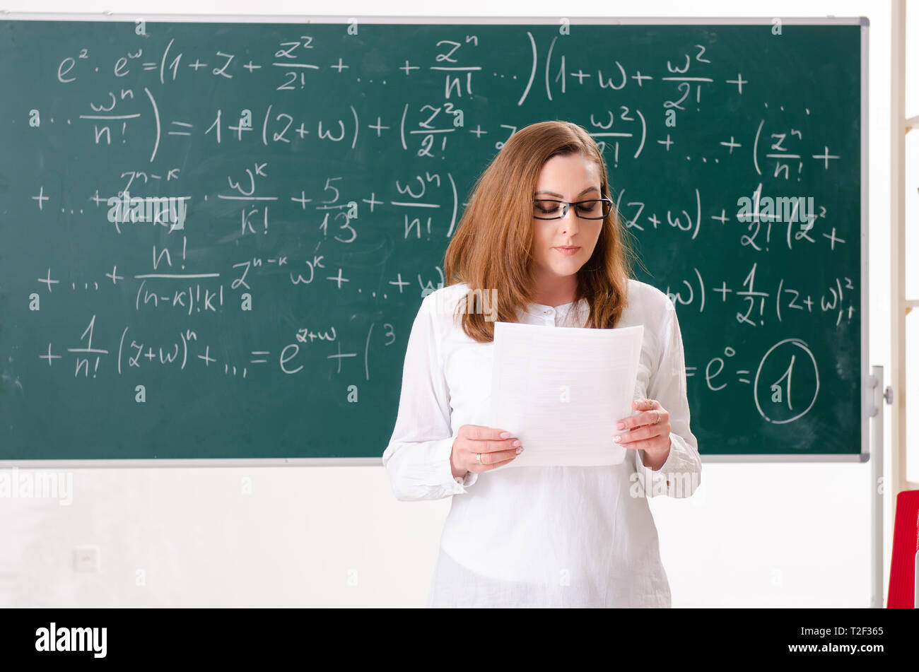 Female math teacher in the classroom Stock Photo - Alamy