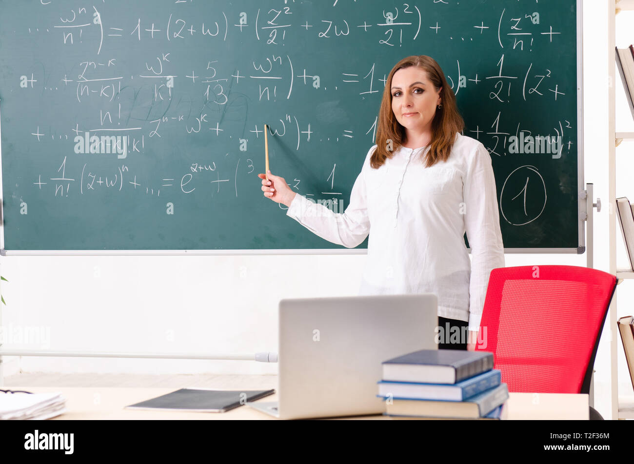 Female math teacher in the classroom Stock Photo - Alamy