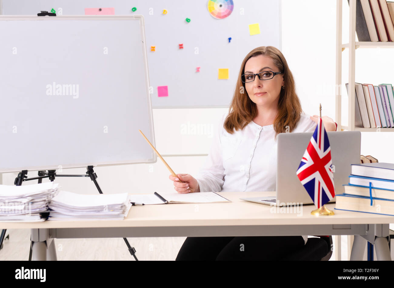 Female english teacher in the classroom Stock Photo - Alamy