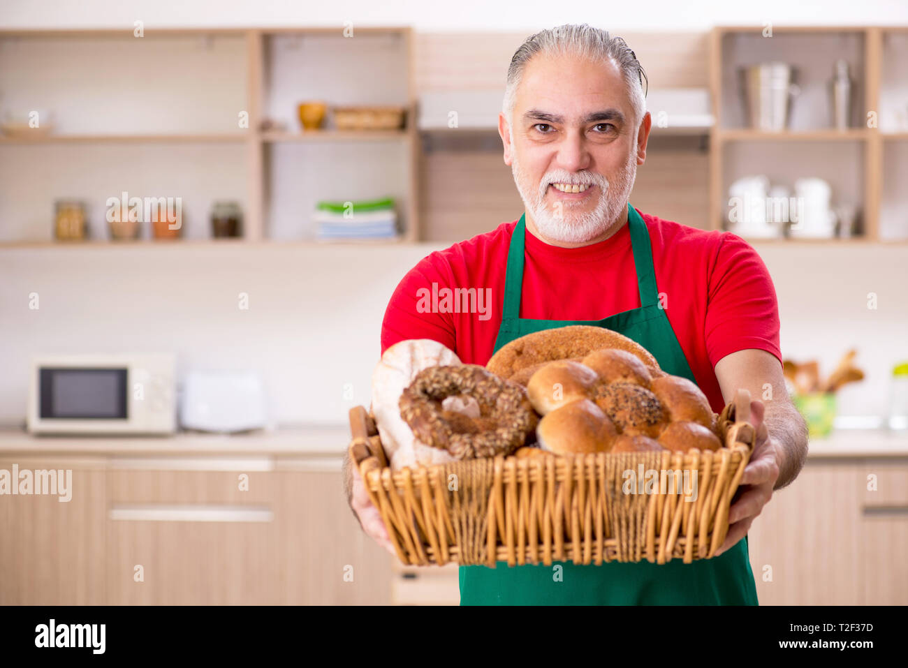 Happy baker presenting loaf bread hi-res stock photography and images ...