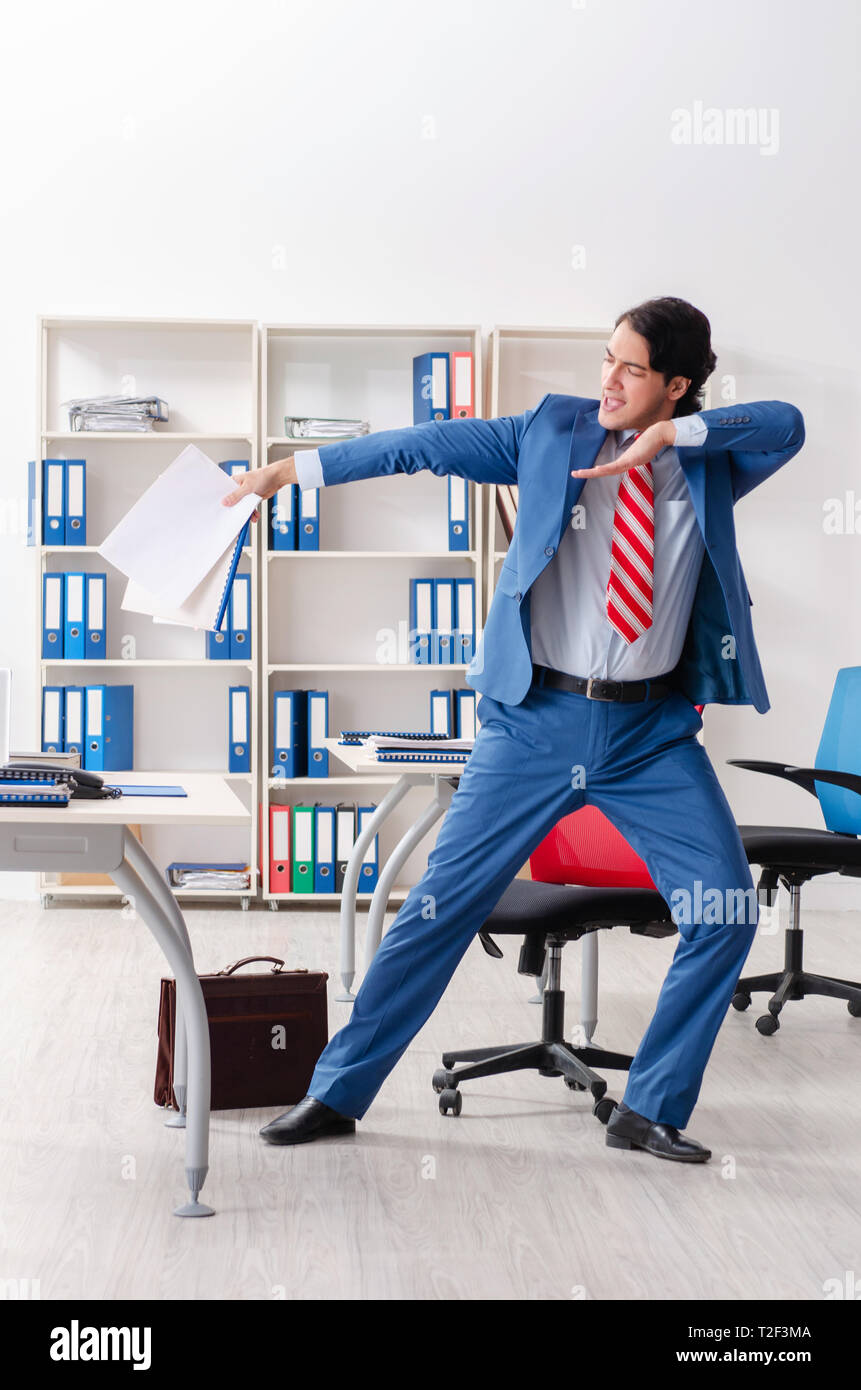 Young happy male employee in the office Stock Photo - Alamy