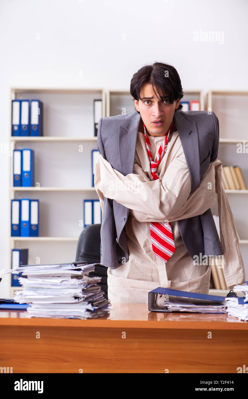 Crazy young man in straitjacket at the office Stock Photo - Alamy