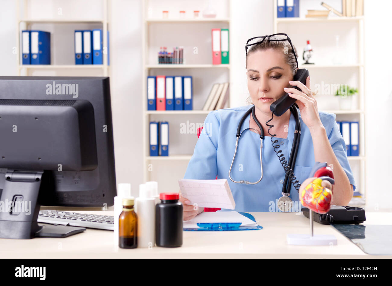 Female doctor cardiologist working in the clinic Stock Photo - Alamy