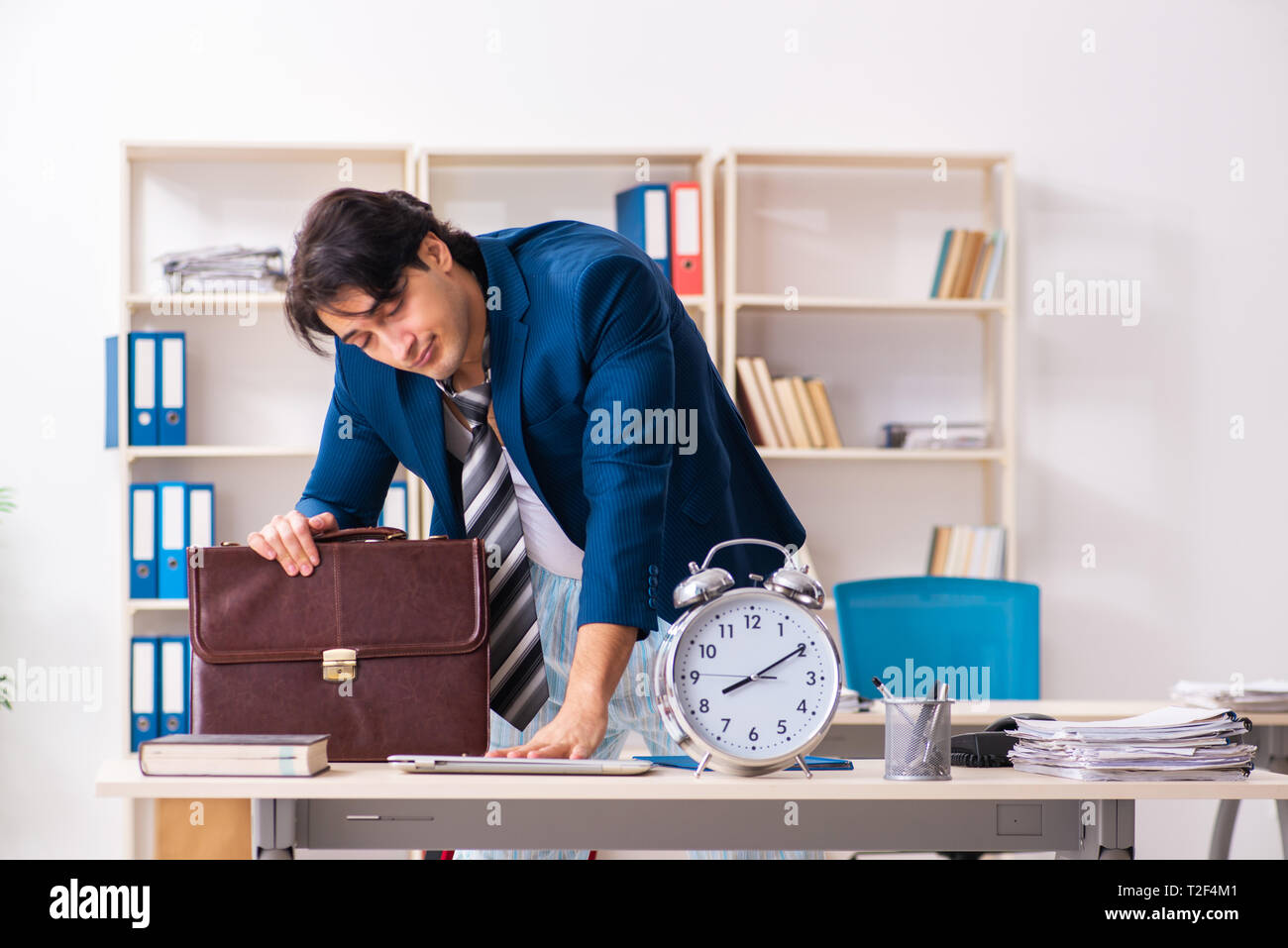 Employee coming to work straight from bed Stock Photo - Alamy