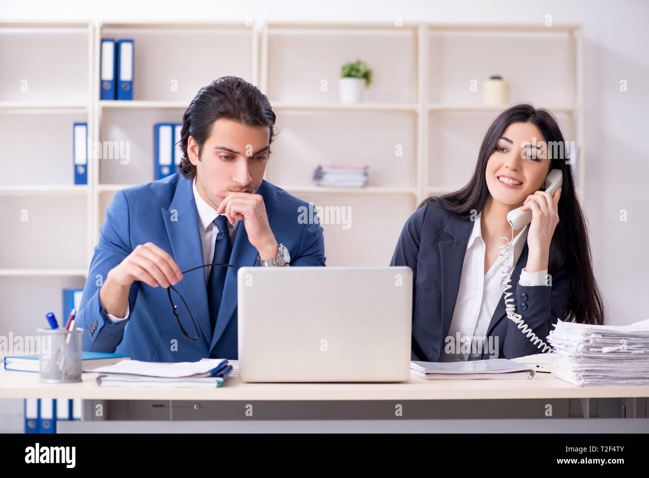 Two employees working in the office Stock Photo - Alamy