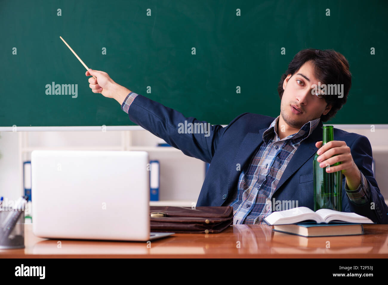 Male teacher drinking in the classroom Stock Photo - Alamy