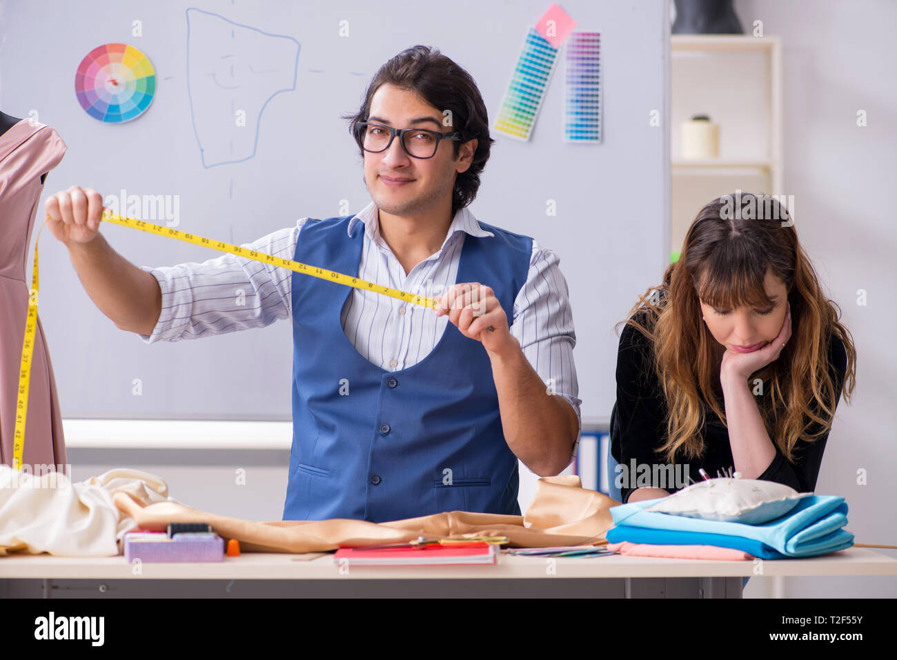 Young tailors working in workshop Stock Photo - Alamy