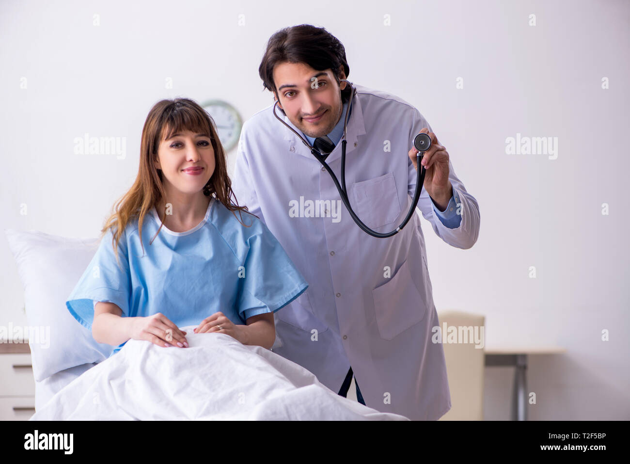 Male doctor visiting female patient in ward hi-res stock photography ...