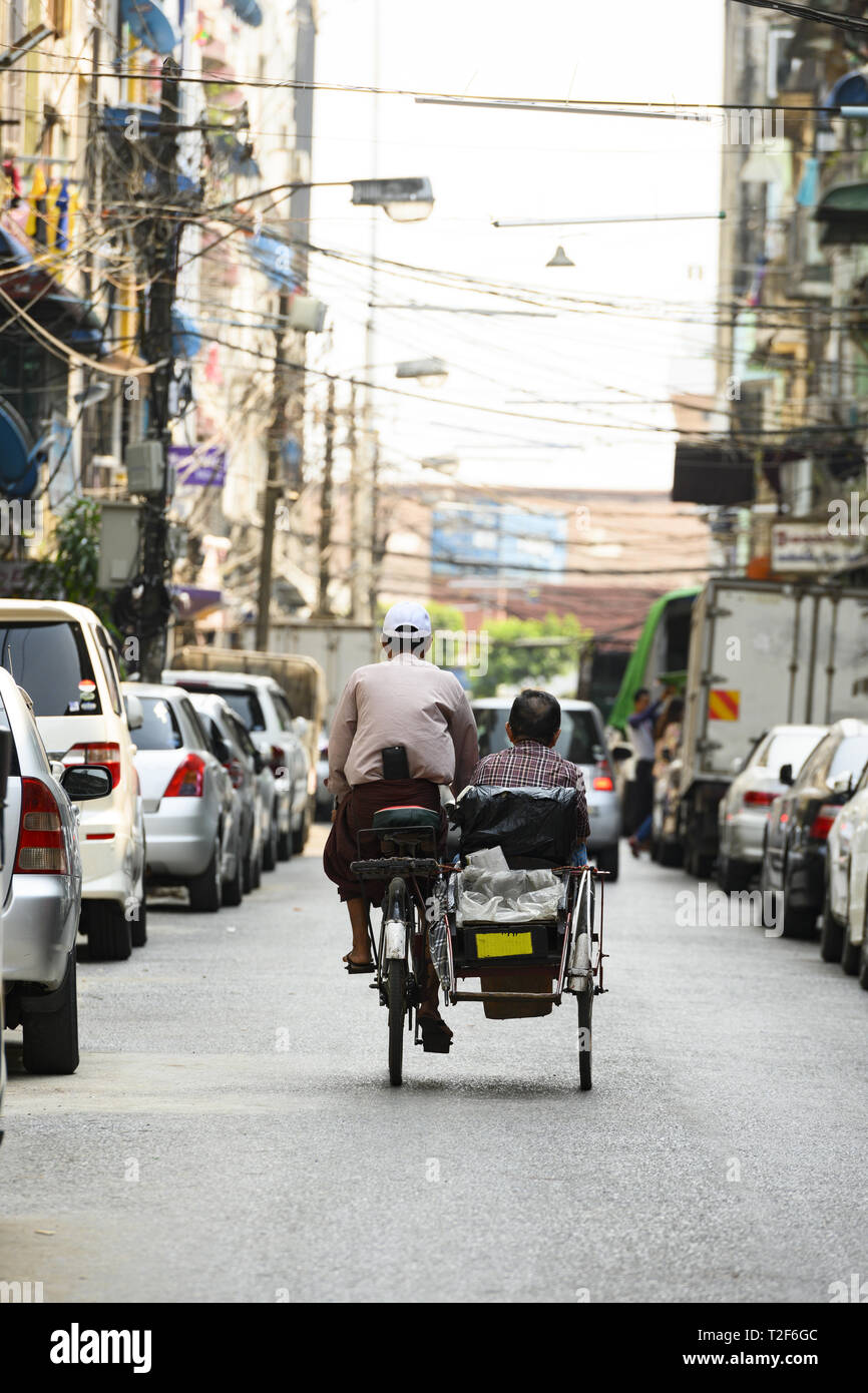 A unidentified Sai Kaa driver is carrying a passenger on his side car ...