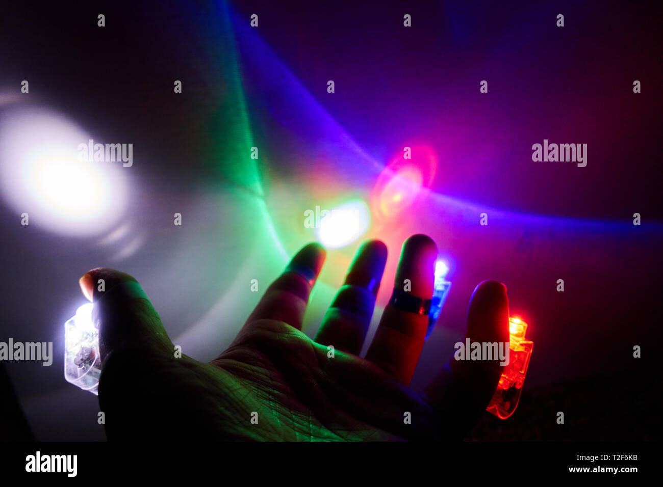 multi-color finger lights on outstretched hand Stock Photo - Alamy