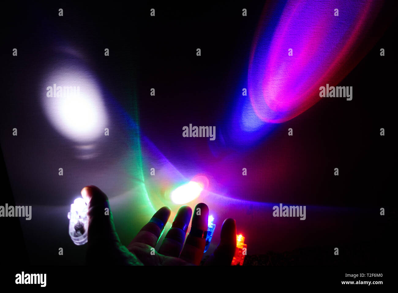 multi-color finger lights on outstretched hand Stock Photo - Alamy