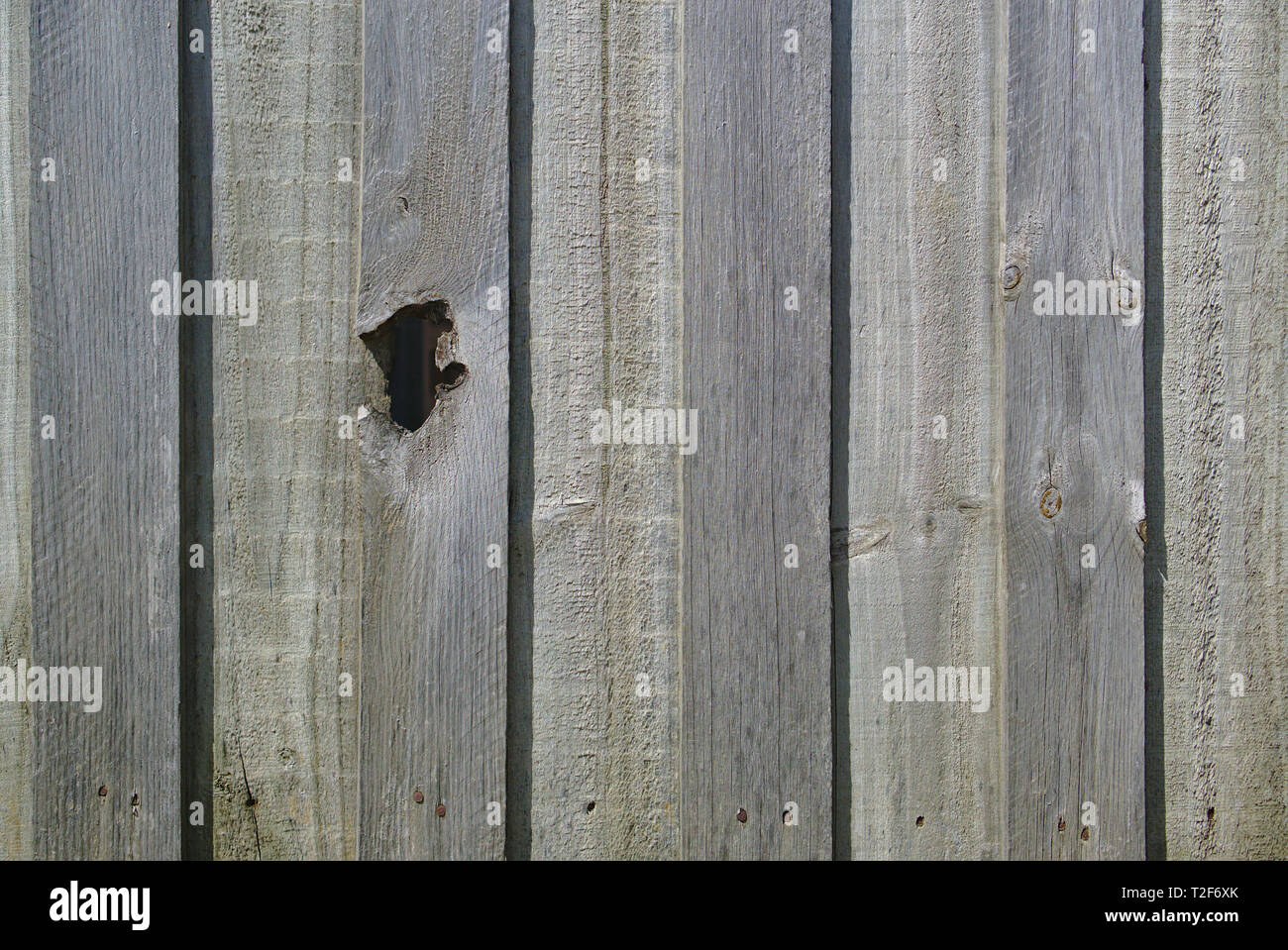 Close up view of hole on wooden fence with vertical lines Stock Photo ...