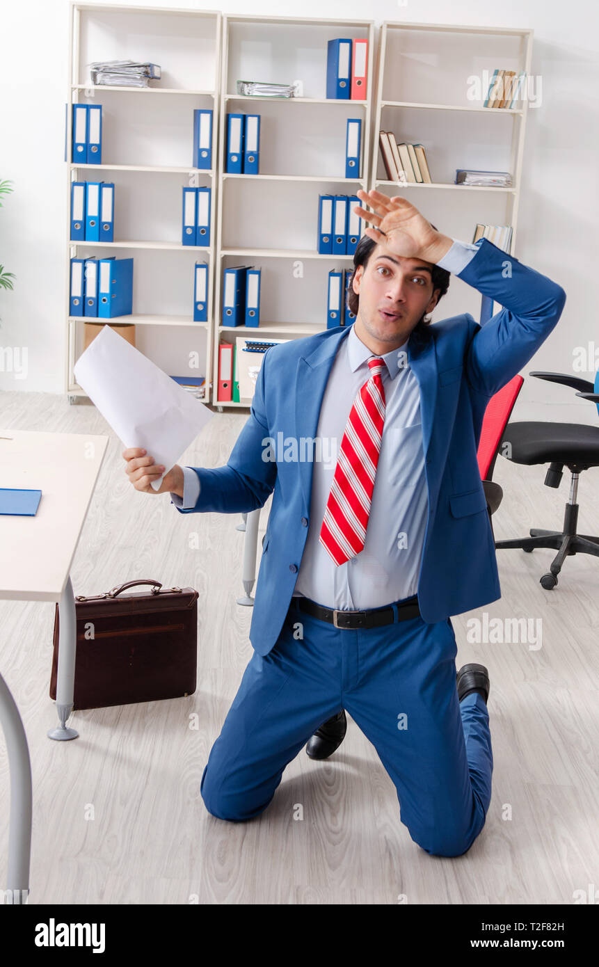 Young happy male employee in the office Stock Photo - Alamy