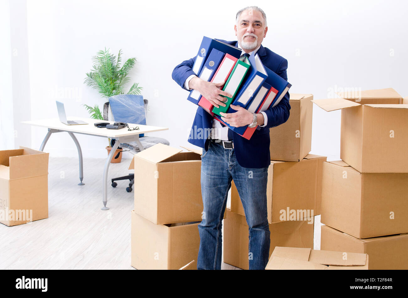 Aged businessman moving to new workplace Stock Photo - Alamy