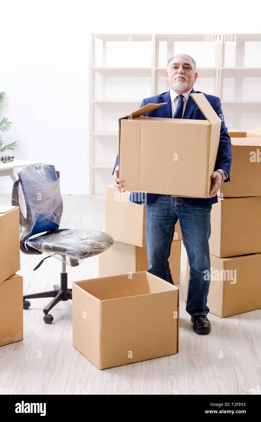 Aged businessman moving to new workplace Stock Photo - Alamy