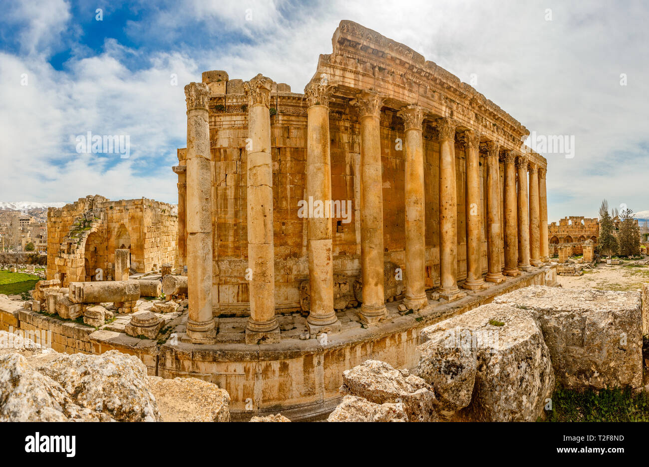Columns of ancient Roman temple of Bacchus with surrounding ruins of ...