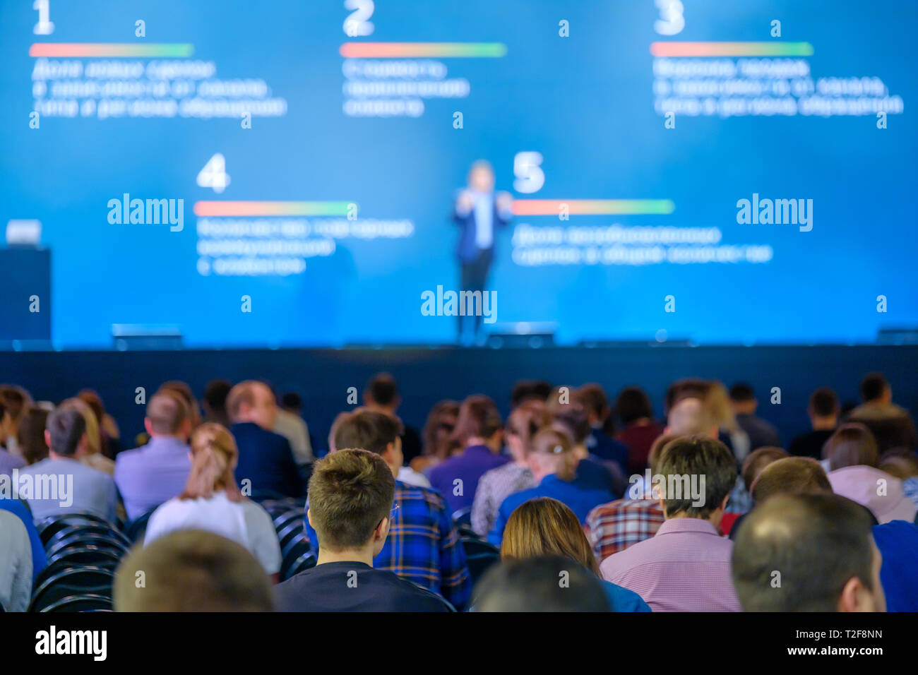Audience listens to the lecturer at the business conference, back view ...