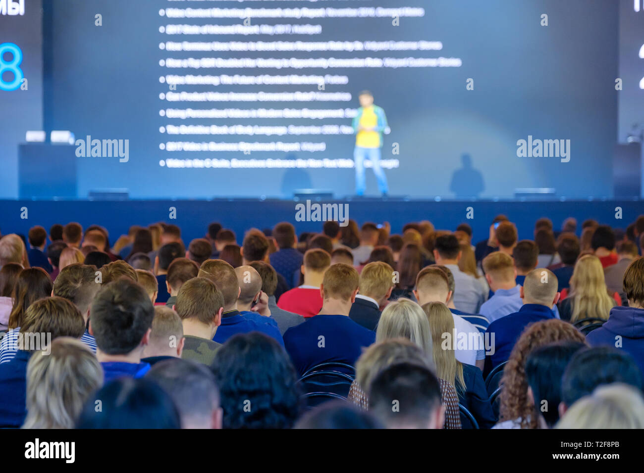 Audience listens to the lecturer at the business conference, back view ...