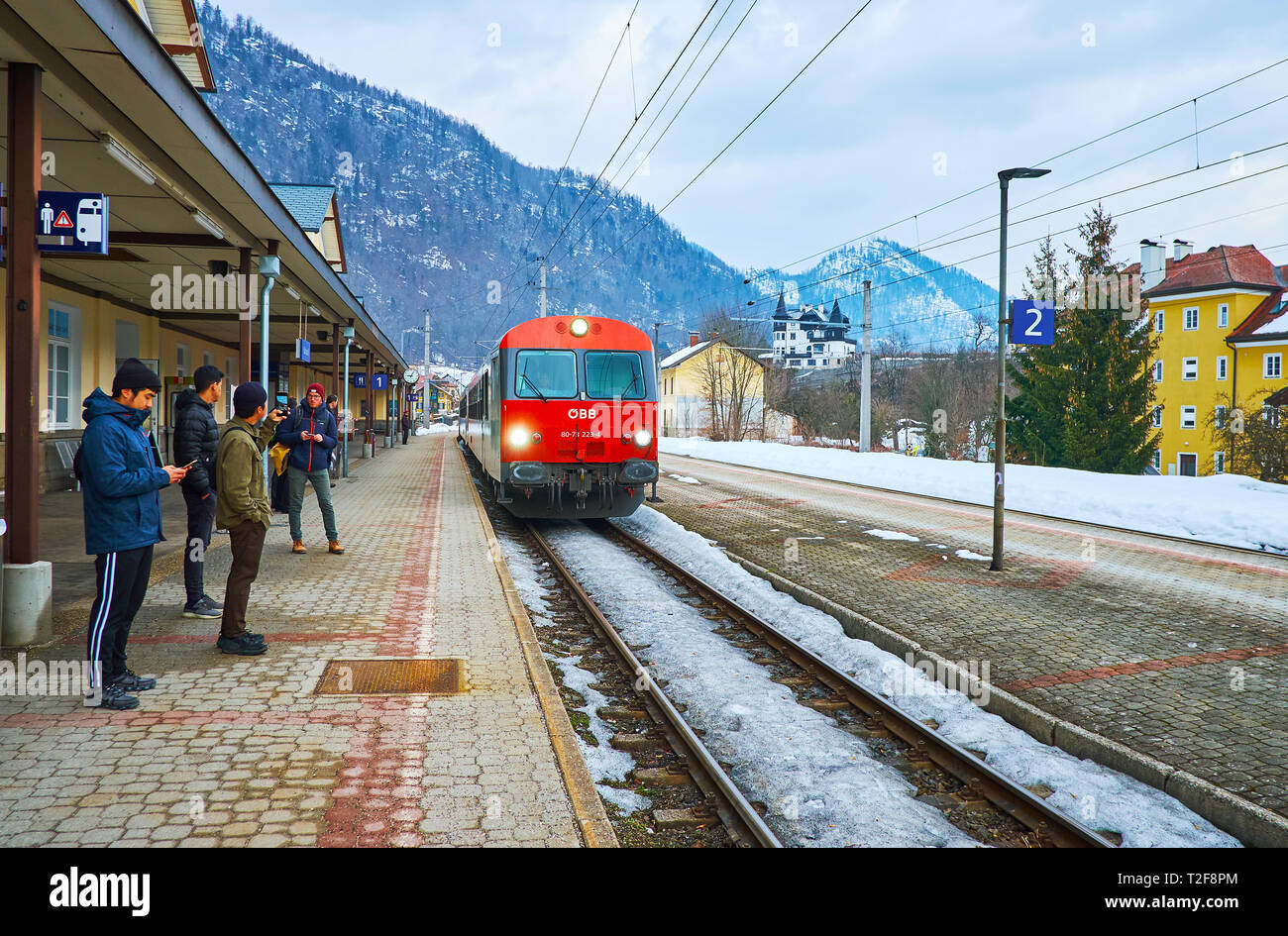 BAD ISCHL, AUSTRIA - FEBRUARY 21, 2019: The modern red train arrives to ...