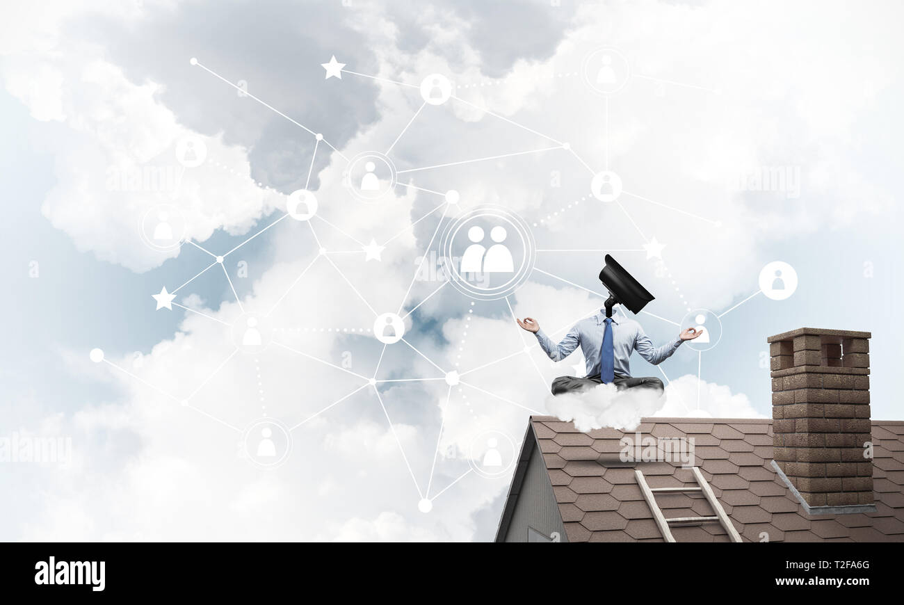 Faceless businessman with camera zoom instead of head sitting in lotus ...