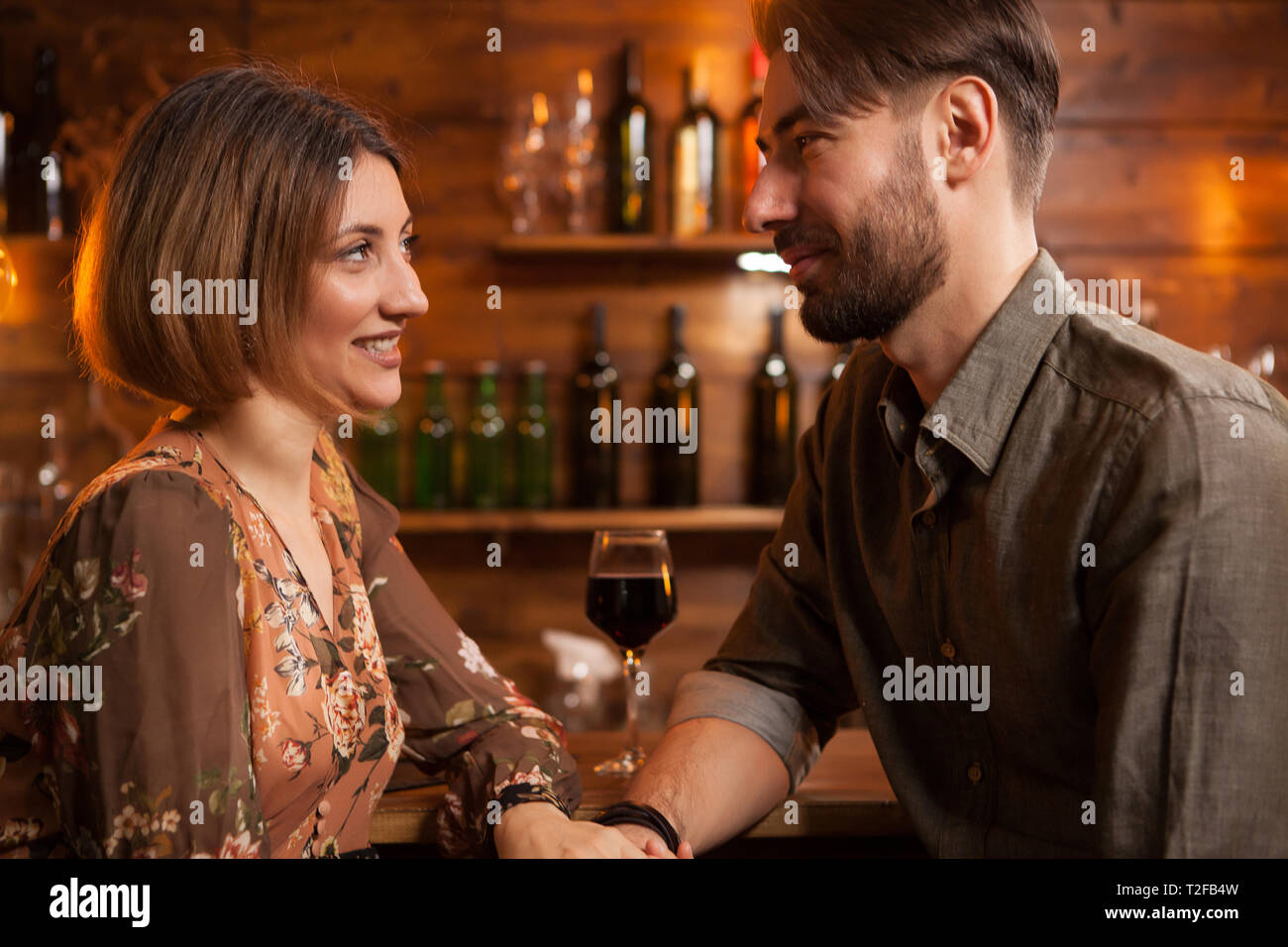 Attractive young woman looking deeply into her boyfriend eyes and ...