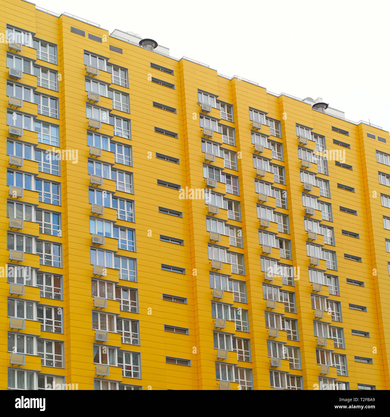 New blocks painted in yellow against the sky, square outdoor image ...