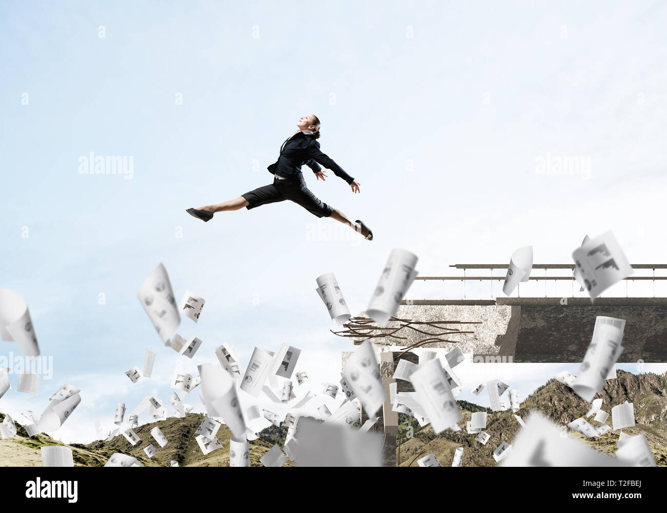 Business woman jumping over gap in bridge among flying papers as symbol ...