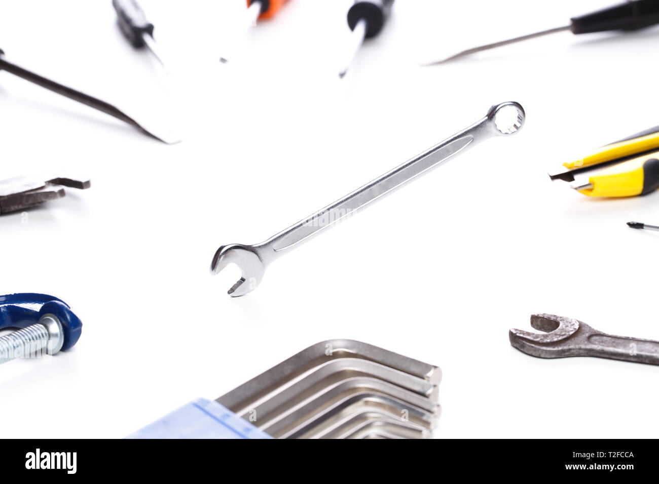 Photo of various tools on clean white background with wrench in the ...
