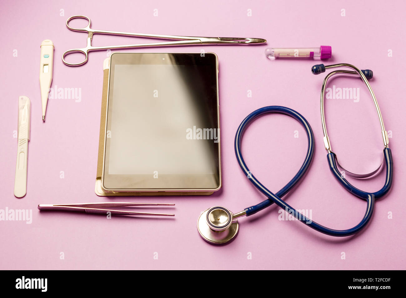 Tablet pc and doctor tools on blue surface. Medical concept Stock Photo ...
