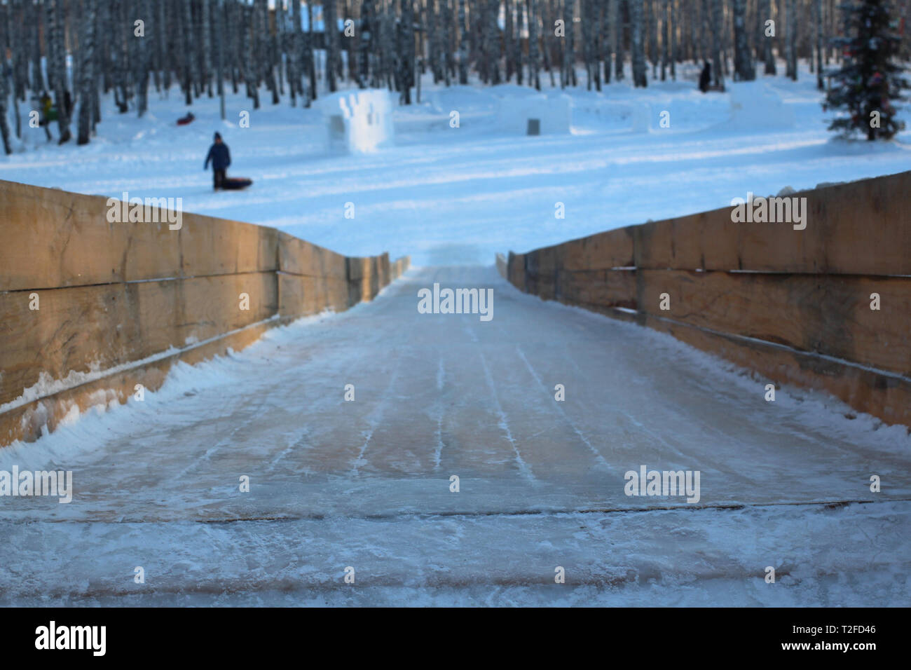high wooden ice slide with steep slope and icy frozen sliding surface ...