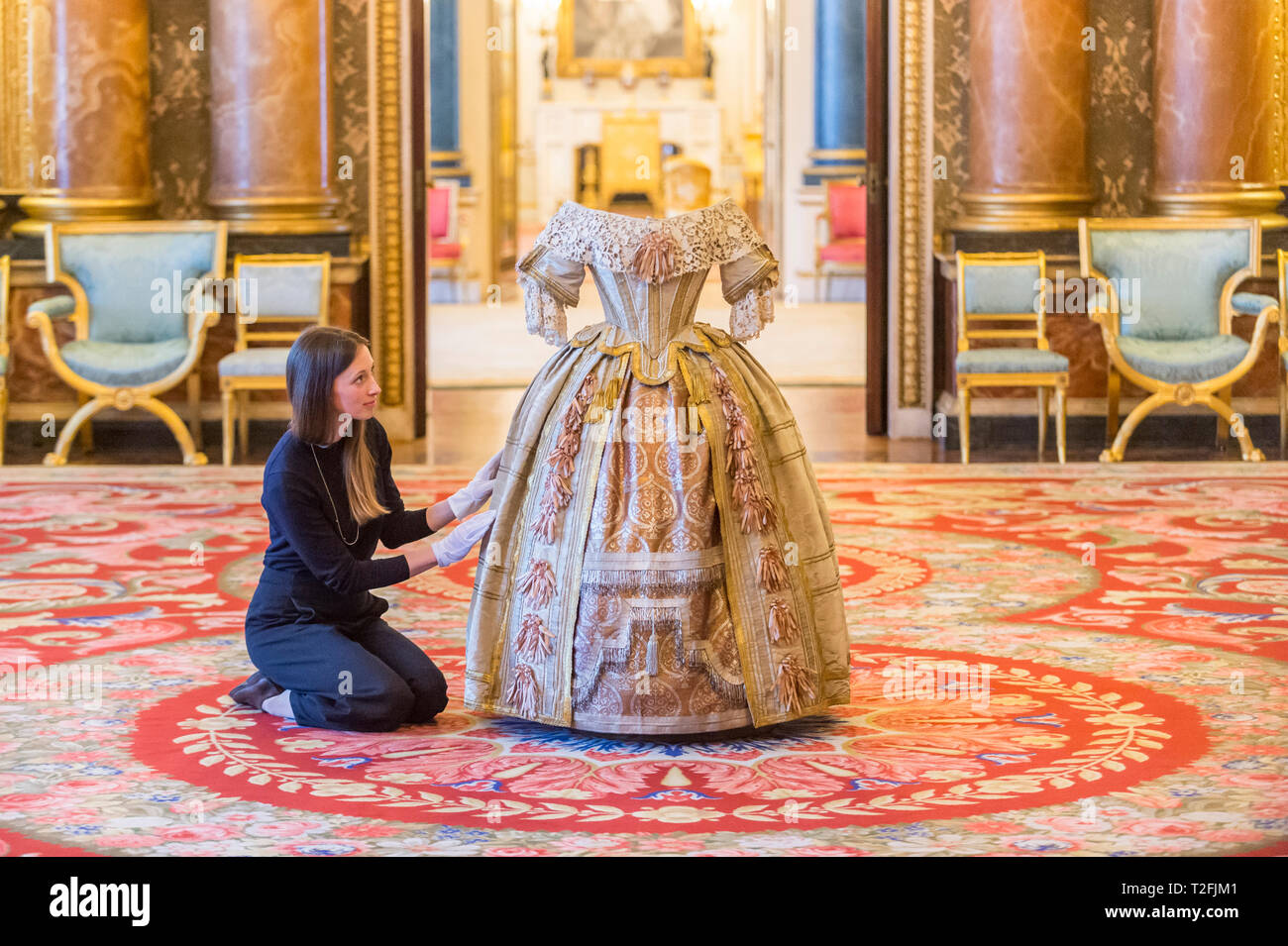 London, UK. 2 April 2019. A curator poses with Queen Victoria's Stuart ...