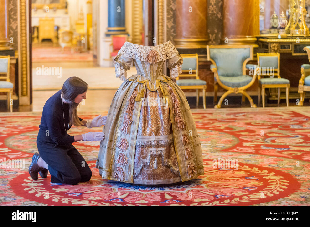 London, UK. 2 April 2019. A curator poses with Queen Victoria's Stuart ...