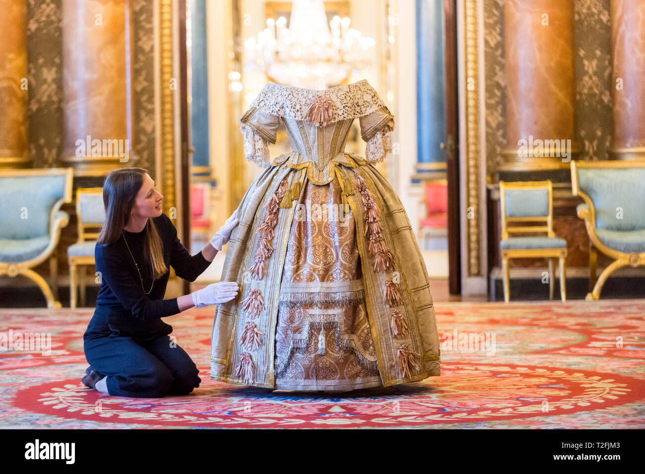 London, UK. 2 April 2019. A curator poses with Queen Victoria's Stuart ...