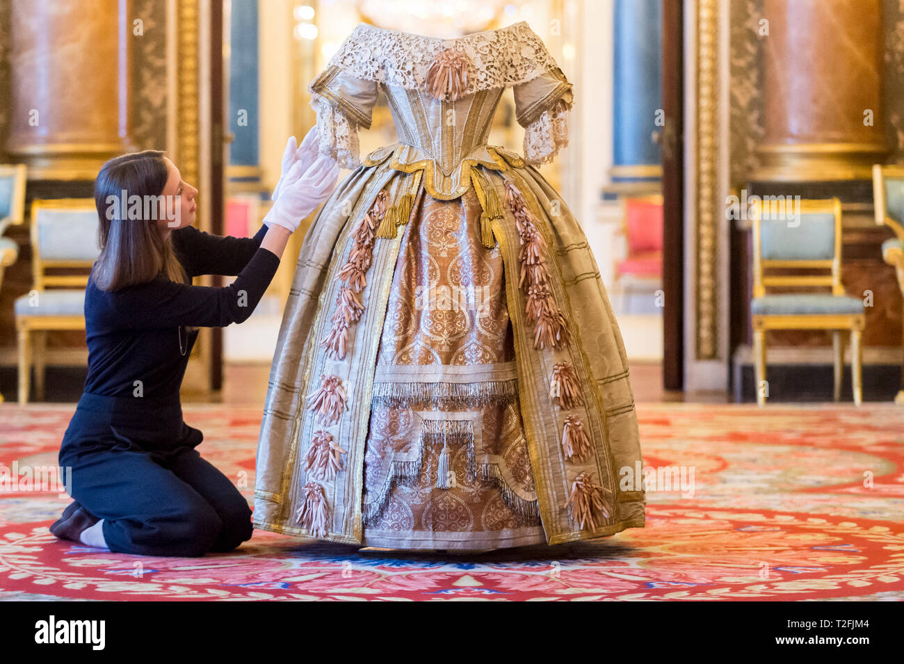 London, UK. 2 April 2019. A curator poses with Queen Victoria's Stuart ...