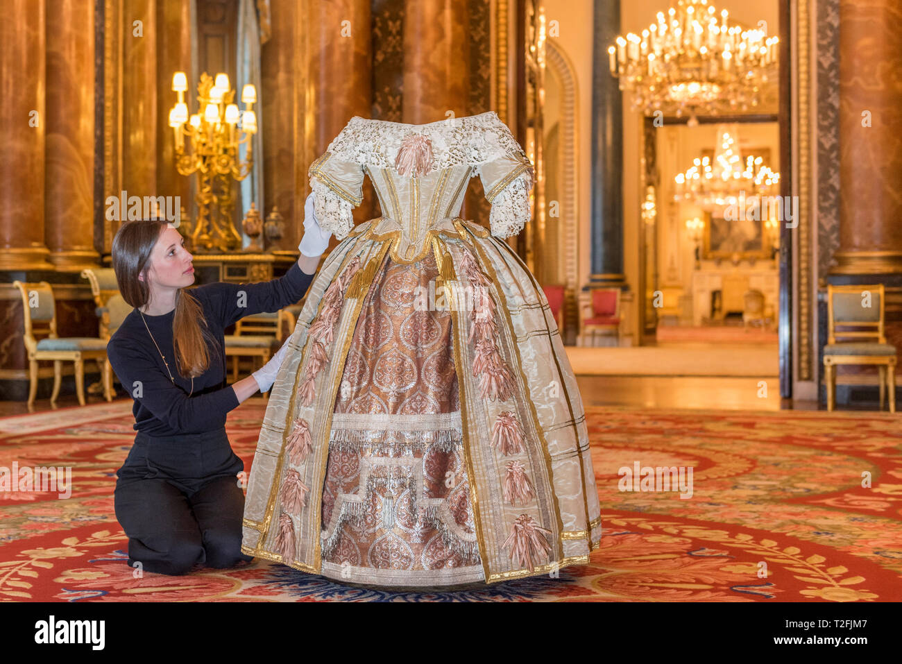London, UK. 2 April 2019. A curator poses with Queen Victoria's Stuart ...