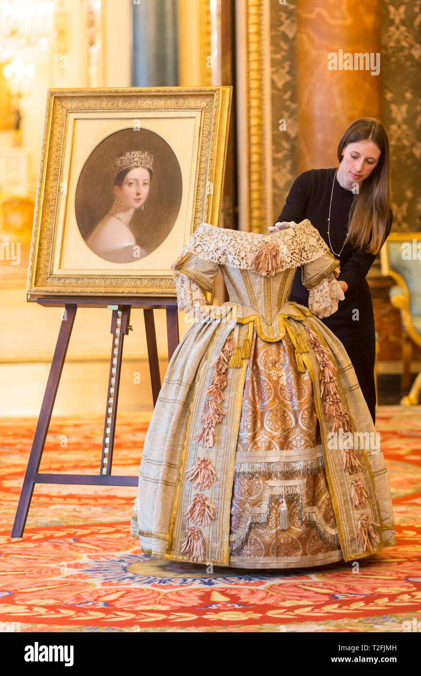 London, UK. 2 April 2019. A curator poses with Queen Victoria's Stuart ...