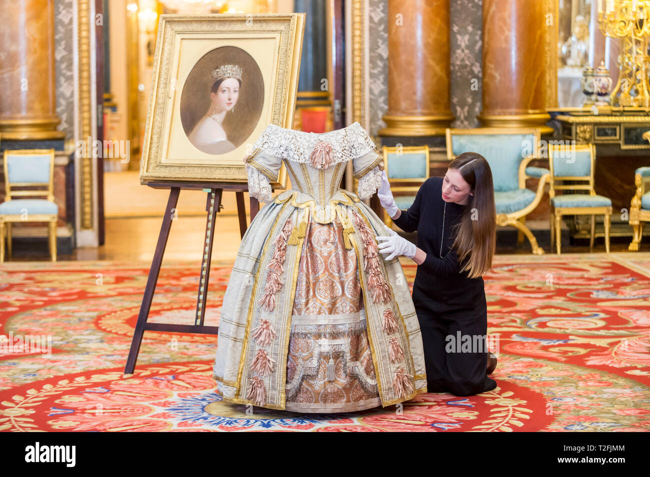 London, UK. 2 April 2019. A curator poses with Queen Victoria's Stuart ...