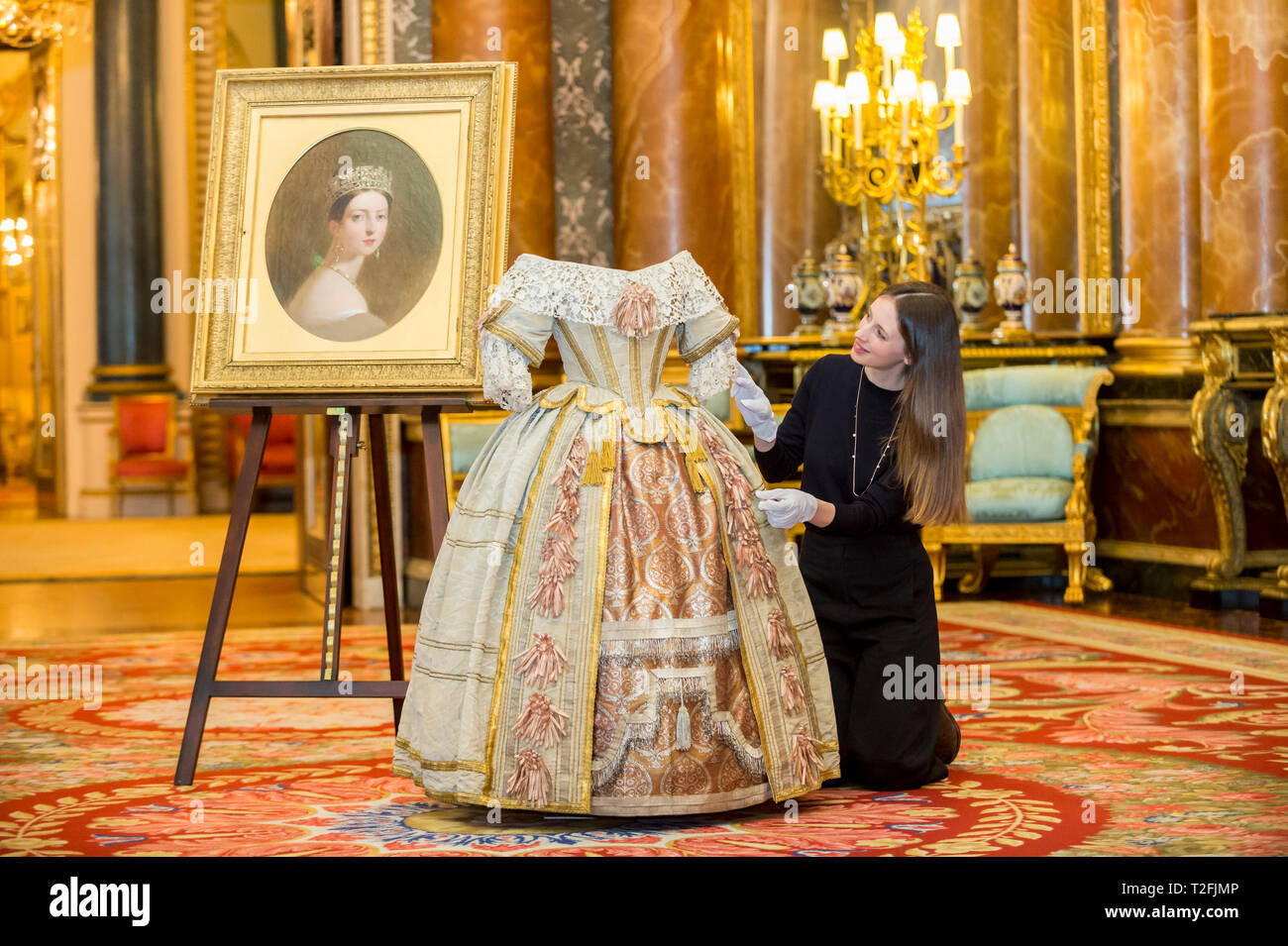 London, UK. 2 April 2019. A curator poses with Queen Victoria's Stuart ...